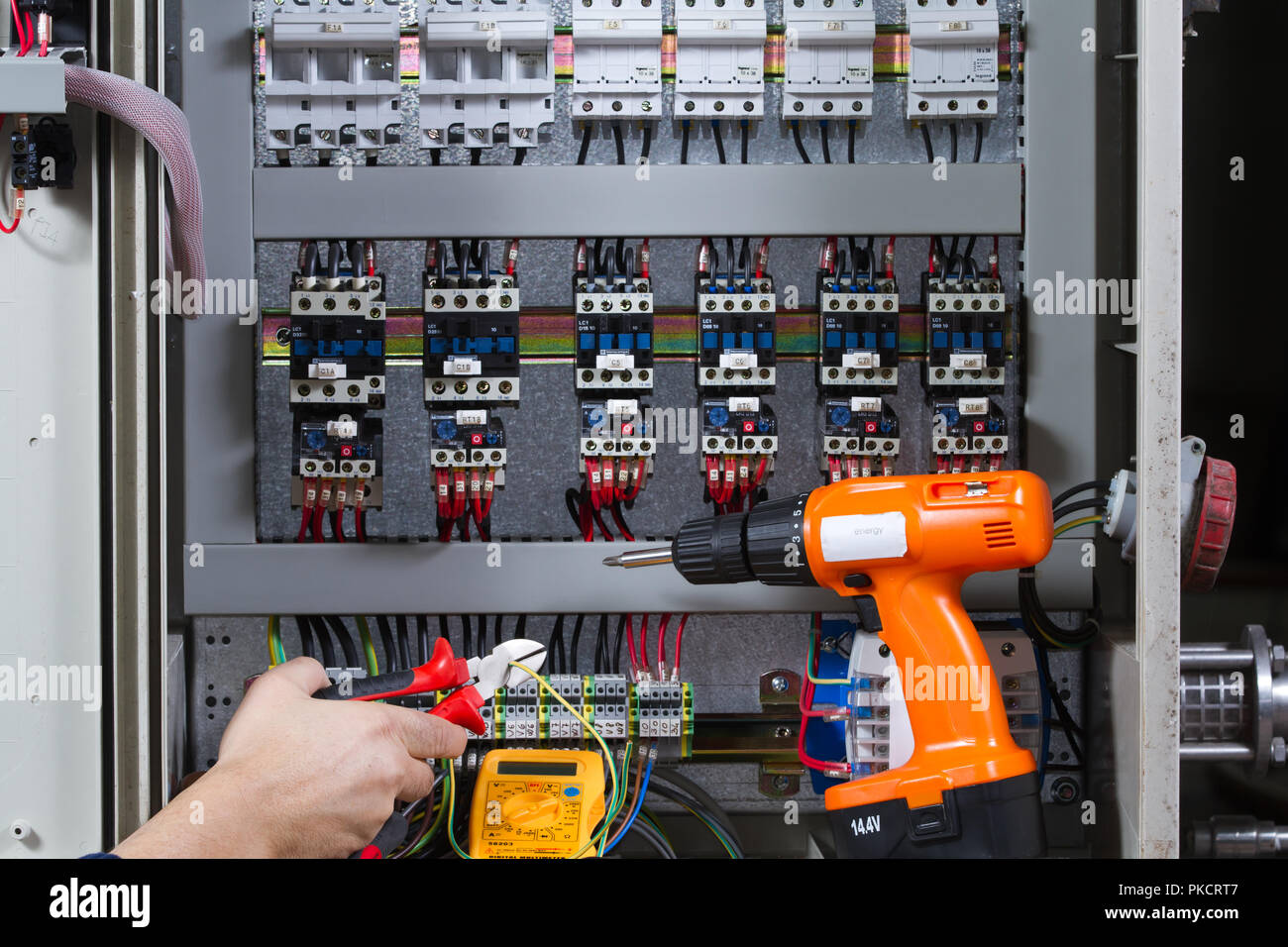electrician at work with an electric panel Stock Photo - Alamy