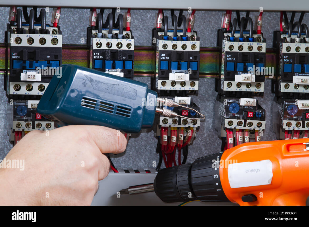electrician at work with an electric panel Stock Photo - Alamy