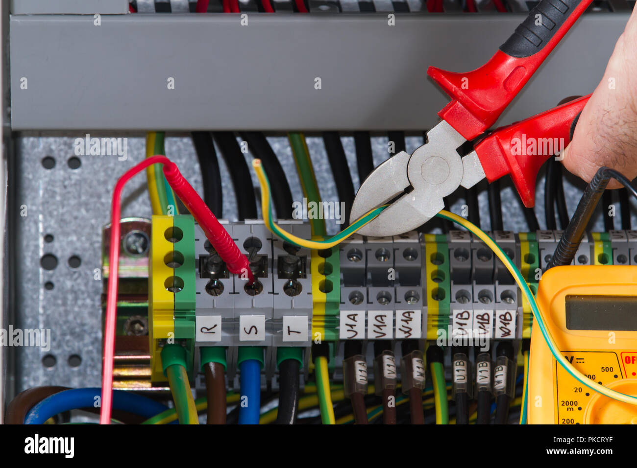 electrician at work with an electric panel Stock Photo - Alamy