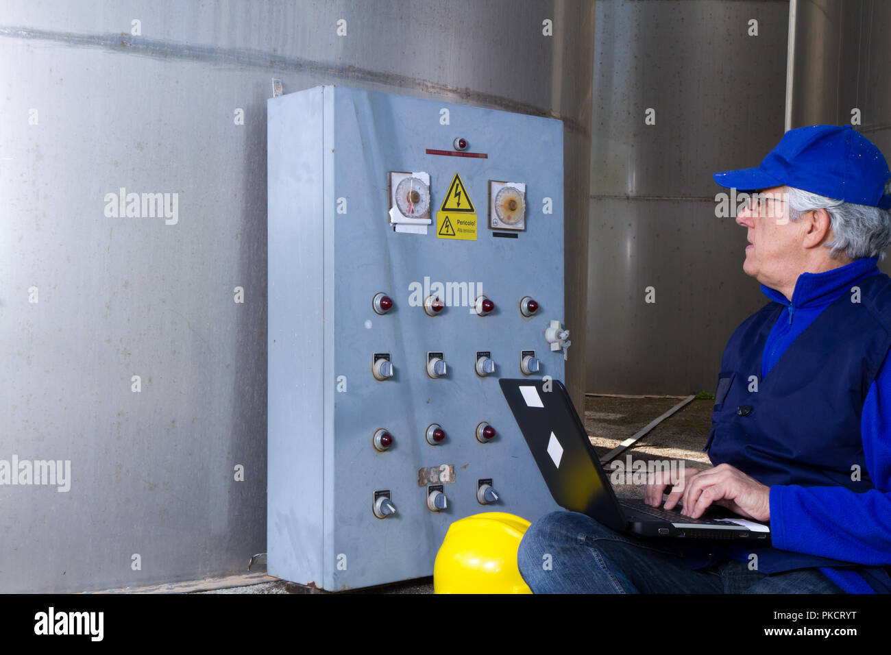 electrician at work with an electric panel Stock Photo - Alamy