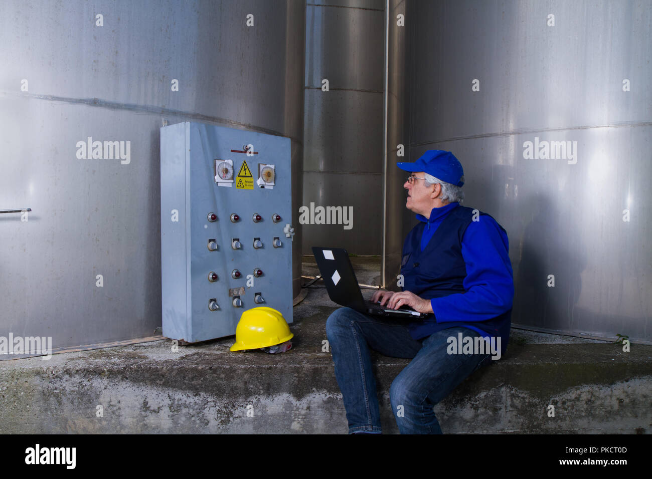 electrician at work with an electric panel Stock Photo - Alamy