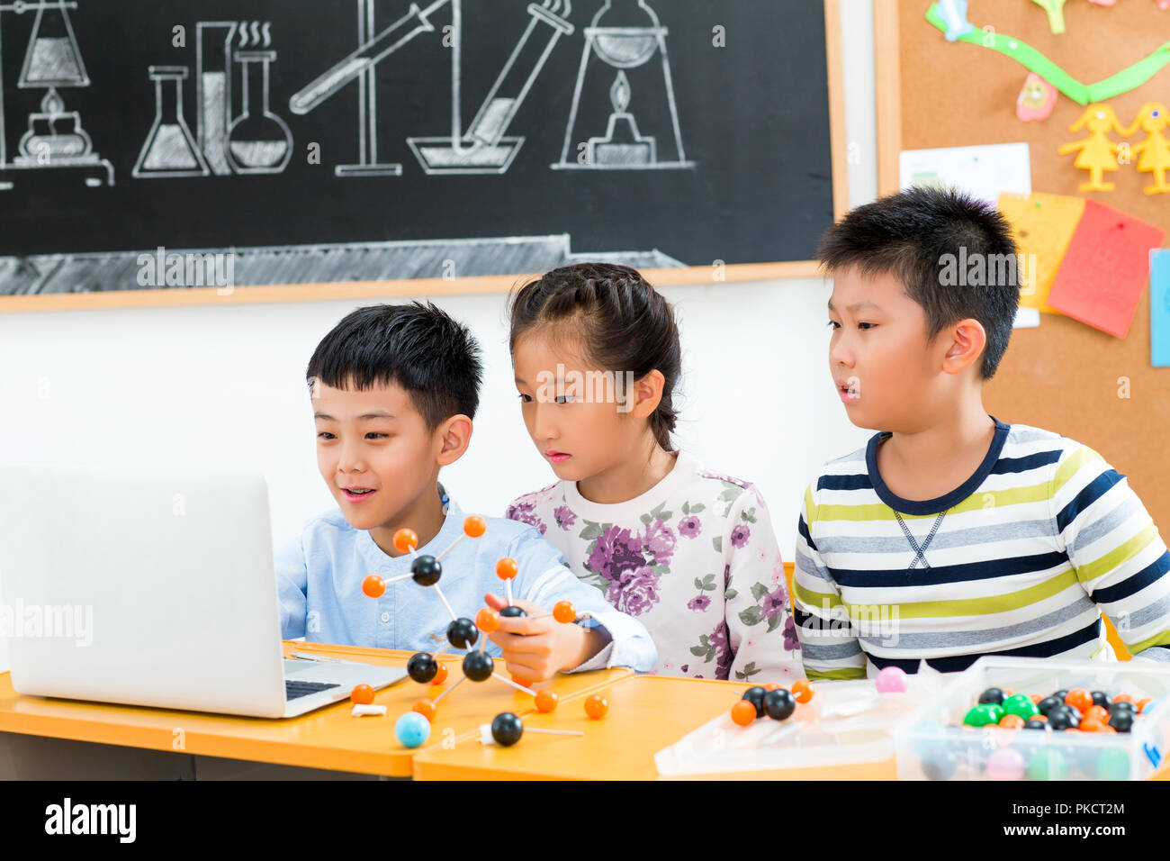 Elementary school students use computers in the classroom Stock Photo ...