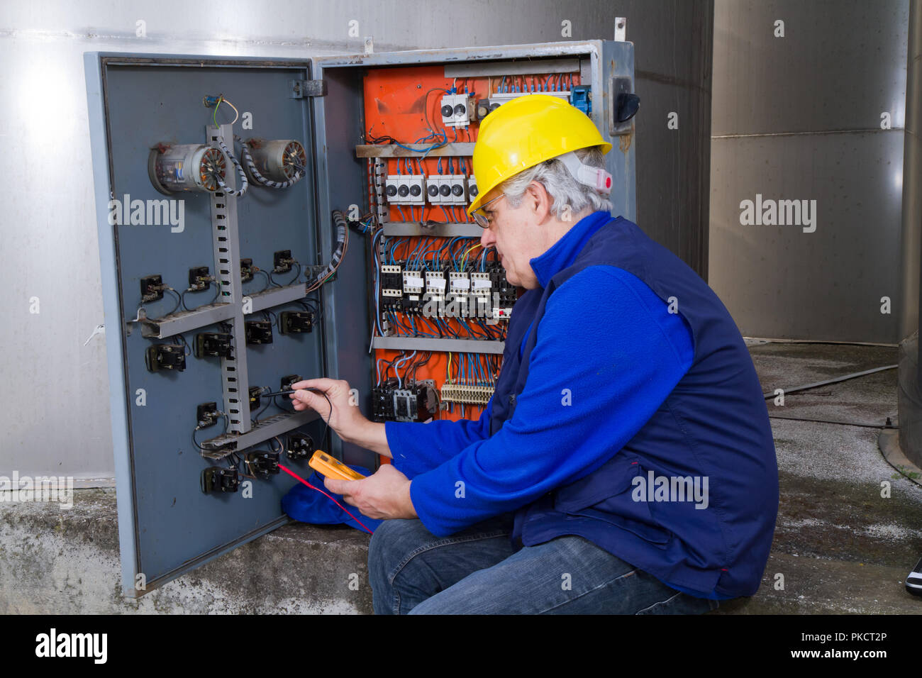 electrician at work with an electric panel Stock Photo - Alamy