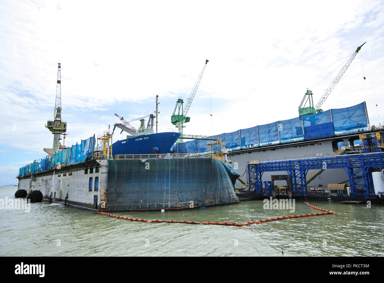 Wide angle view of Large commercial ships into floating repair dock ...