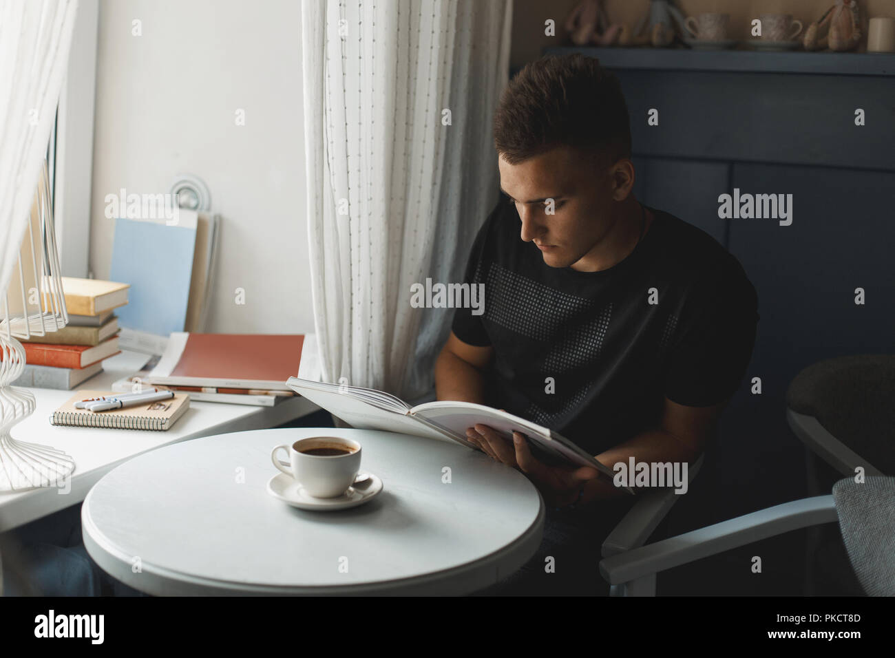 Young caucasian man reading book hi-res stock photography and images ...