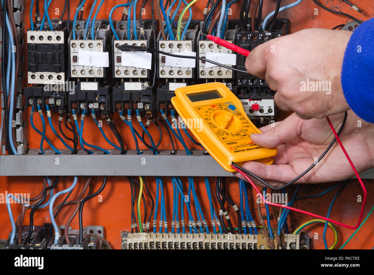 electrician at work with an electric panel Stock Photo - Alamy