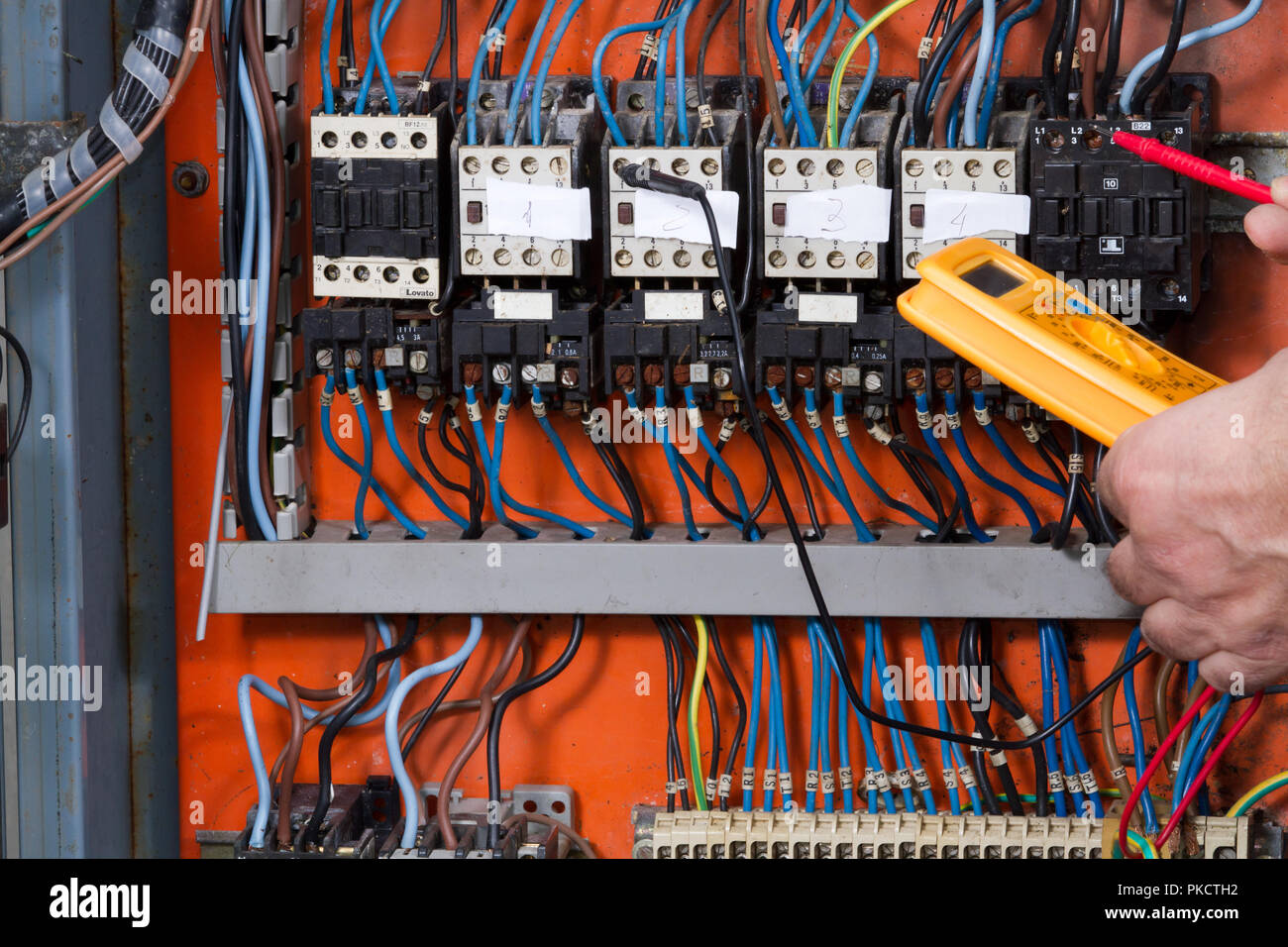 electrician at work with an electric panel Stock Photo - Alamy