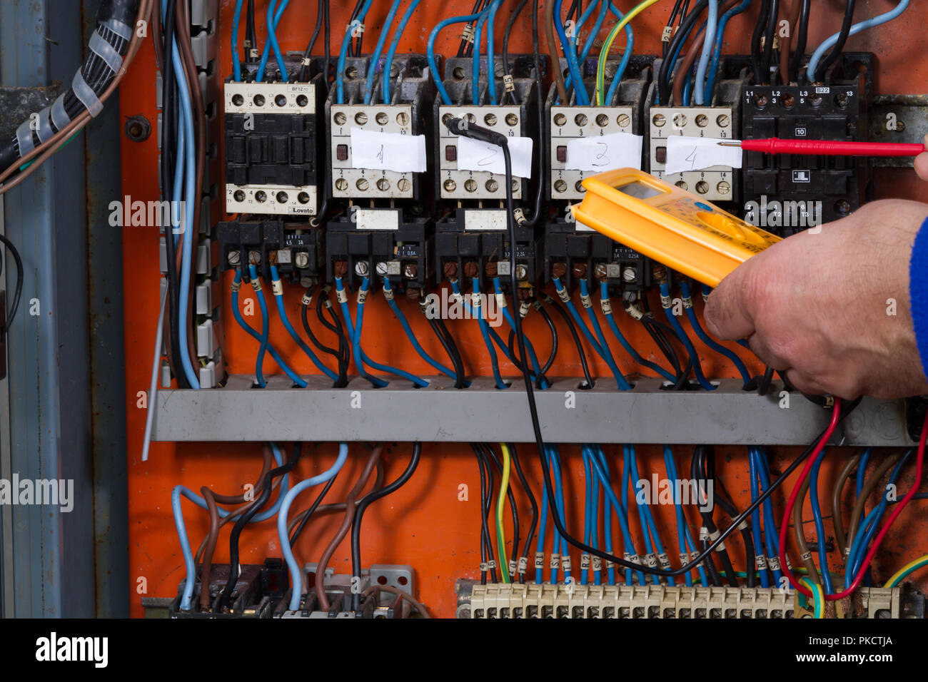 electrician at work with an electric panel Stock Photo - Alamy