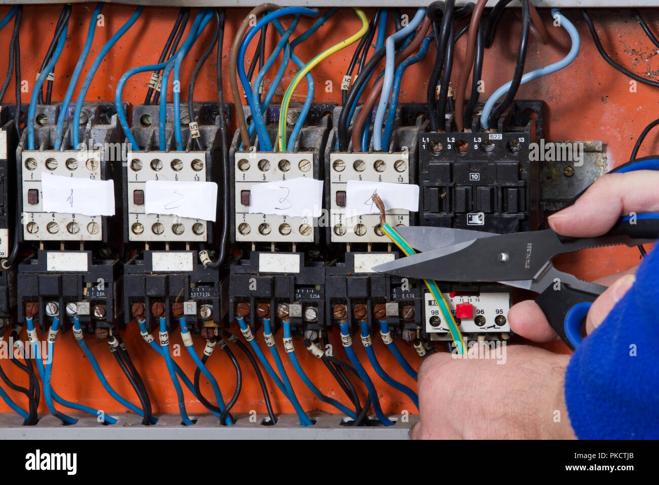 electrician at work with an electric panel Stock Photo - Alamy