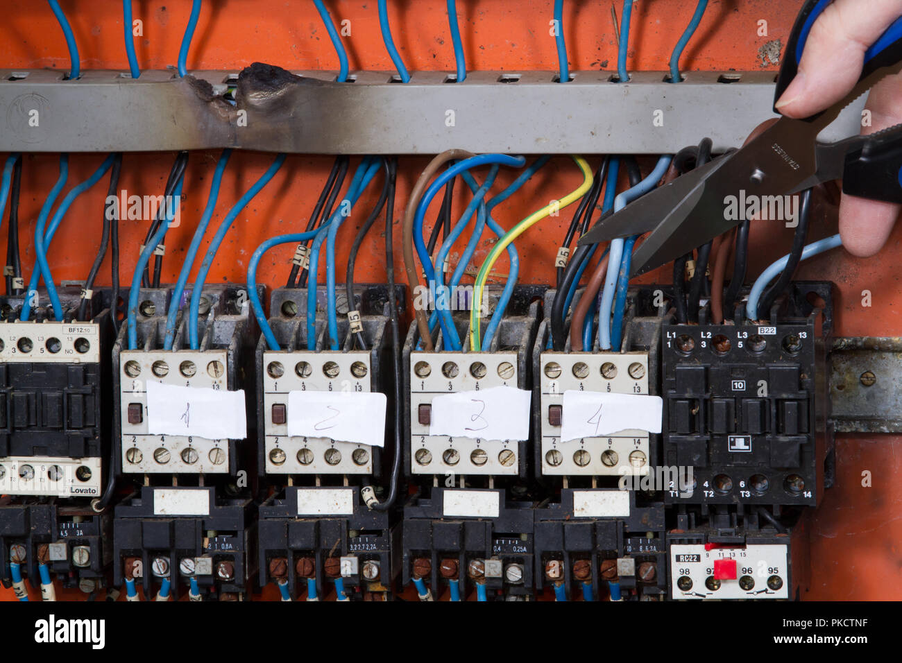 electrician at work with an electric panel Stock Photo - Alamy