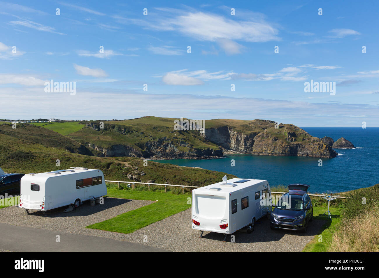 Caravans on a pitch by a beautiful coast scene in summer with blue sea ...