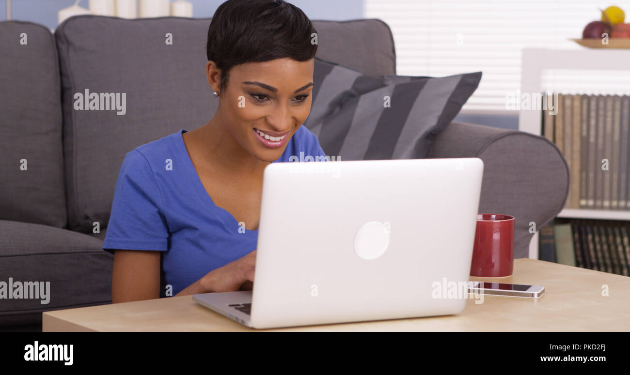 Black woman smiling with laptop Stock Photo - Alamy