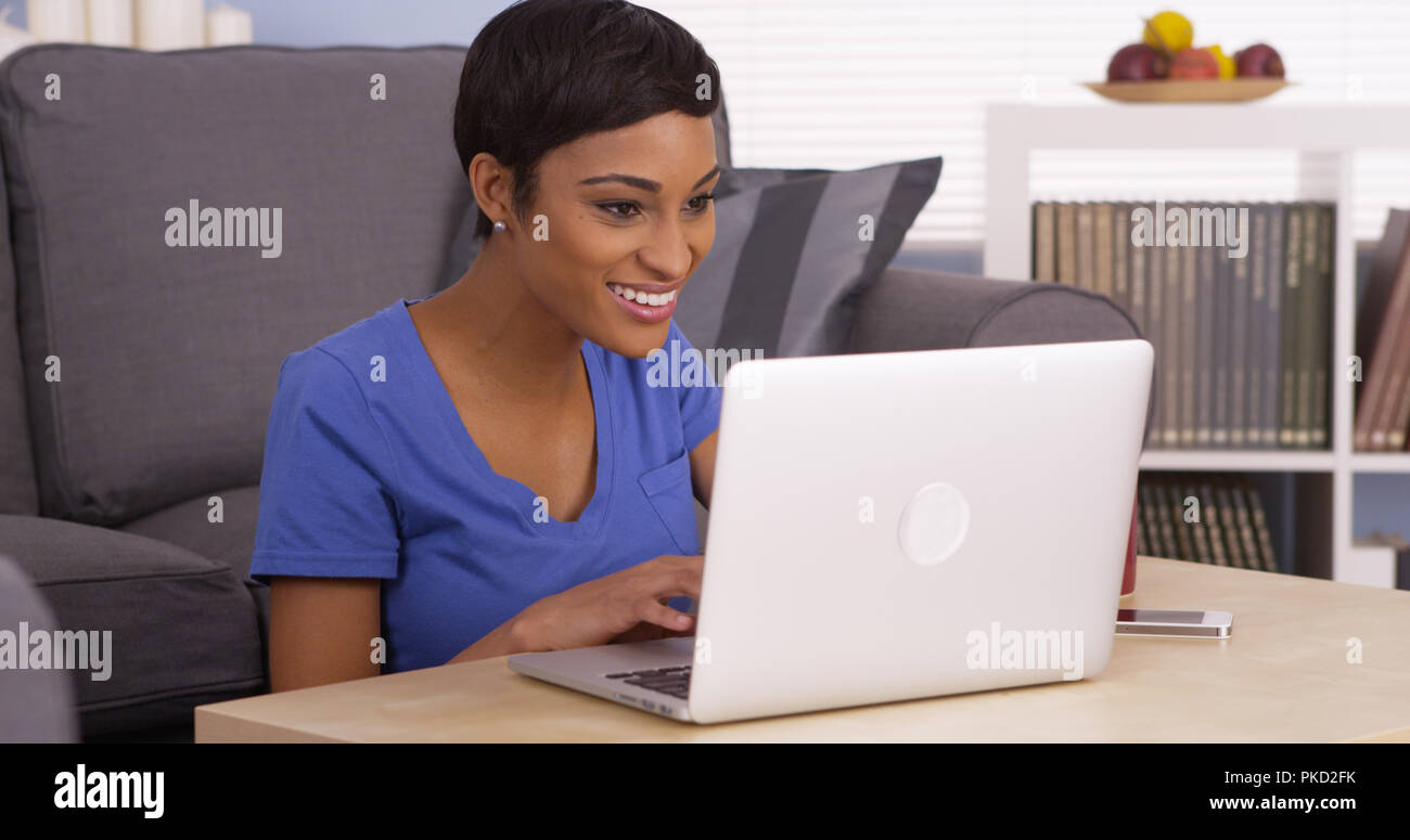 African woman happy using laptop Stock Photo - Alamy