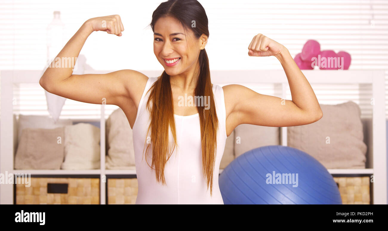 Strong Chinese woman showing off muscles Stock Photo - Alamy