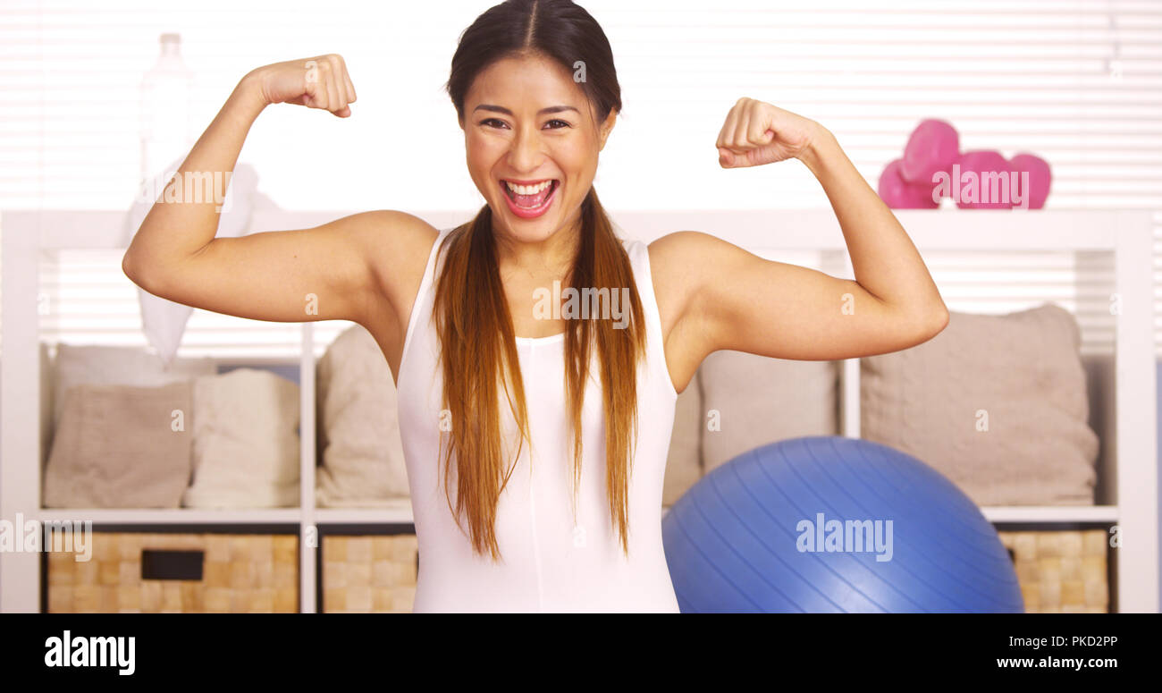 Strong Japanese woman showing off muscles Stock Photo - Alamy