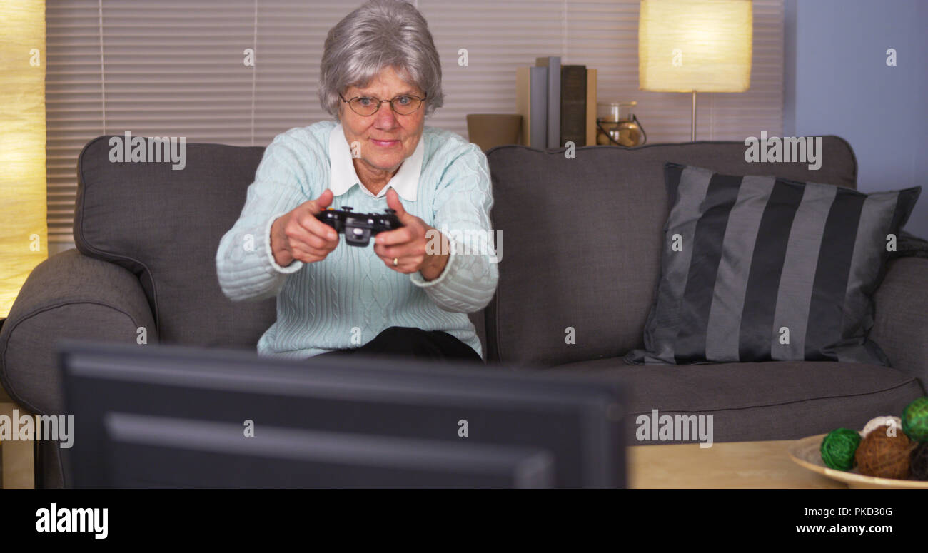 Elderly woman playing video games Stock Photo - Alamy