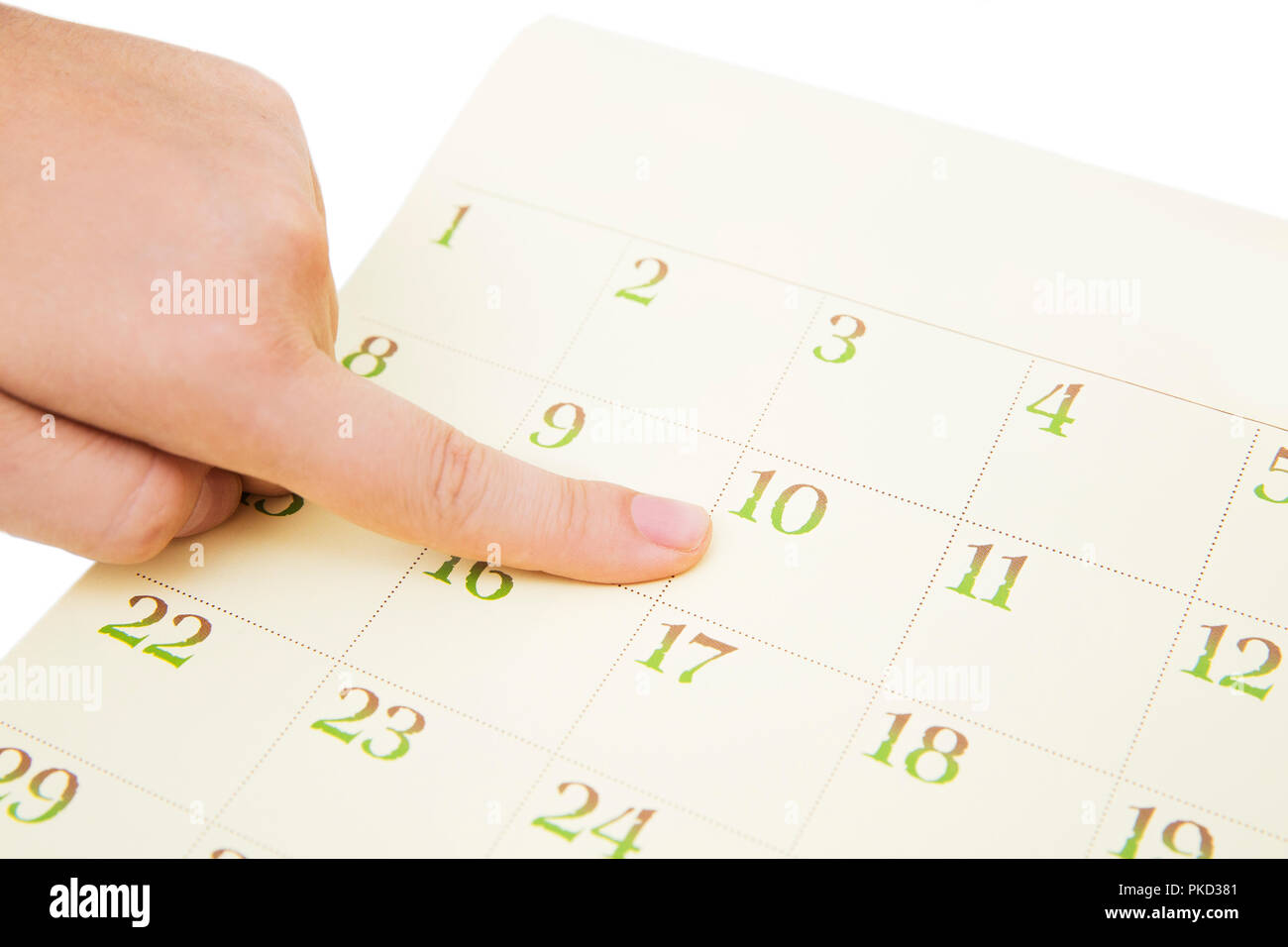 female's finger showing date in a calendar on white background. number ...