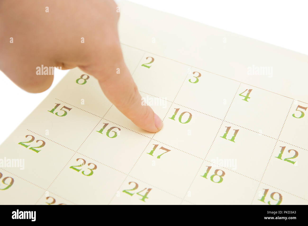 female's finger showing date in a calendar on white background. number ...