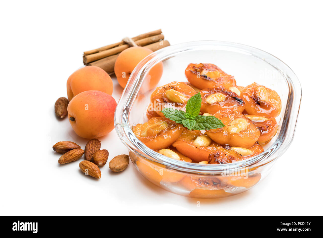 Caramelized apricots with almonds isolated on white Stock Photo - Alamy