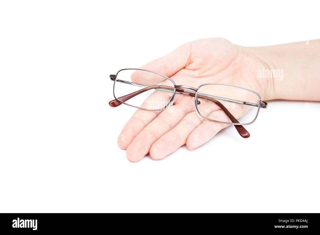Female's hand holding glasse on white background. Glasses in hand ...