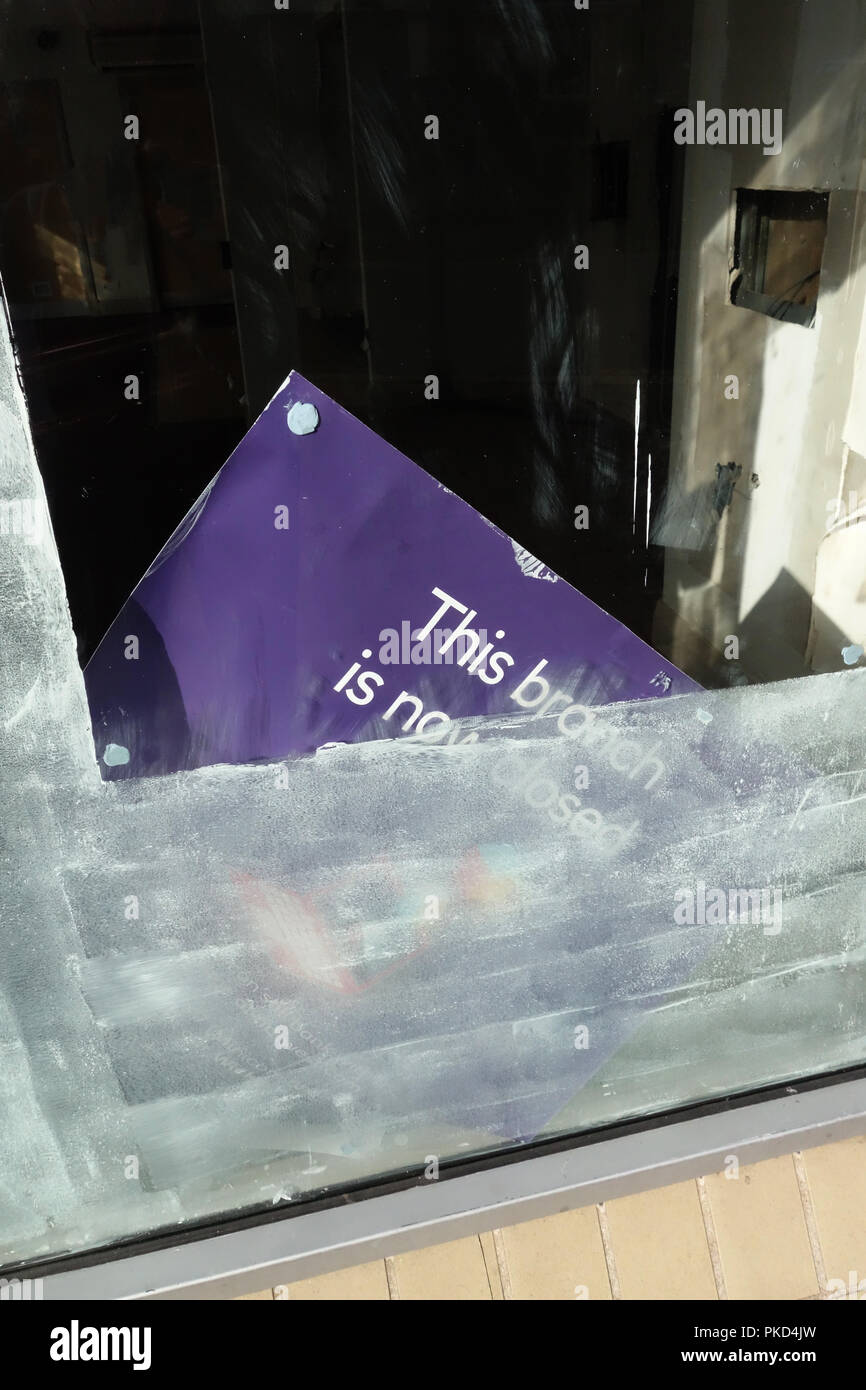 Closeup of Bank closure signs in ex bank window at a Nat West Bank ...