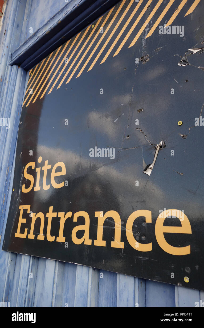 Site Entrance sign on old tatty blue door Stock Photo - Alamy