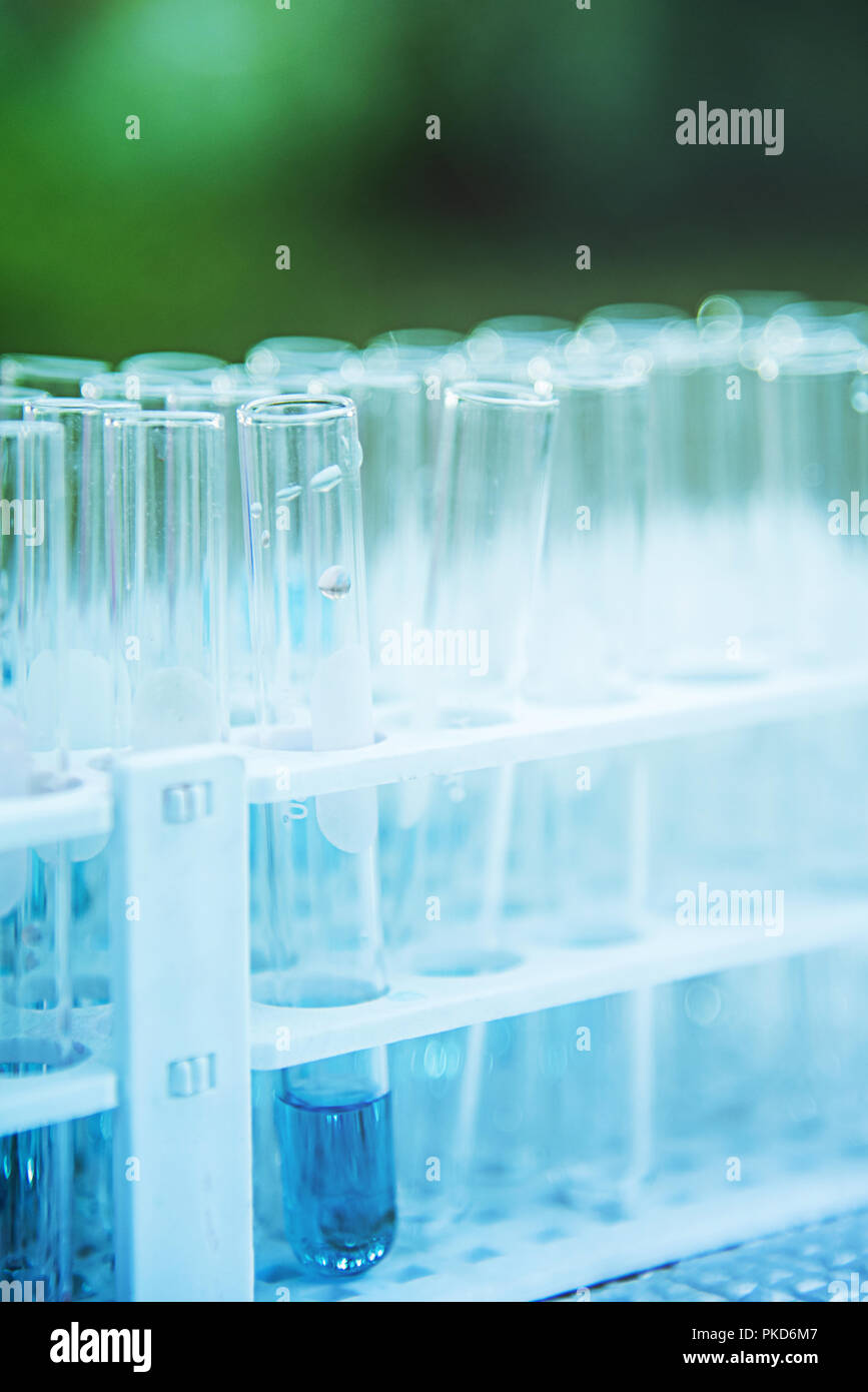 Lab science research glass items adding drop to one of several test ...
