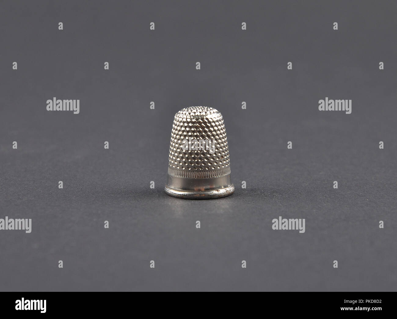 Thimble on black background Stock Photo - Alamy