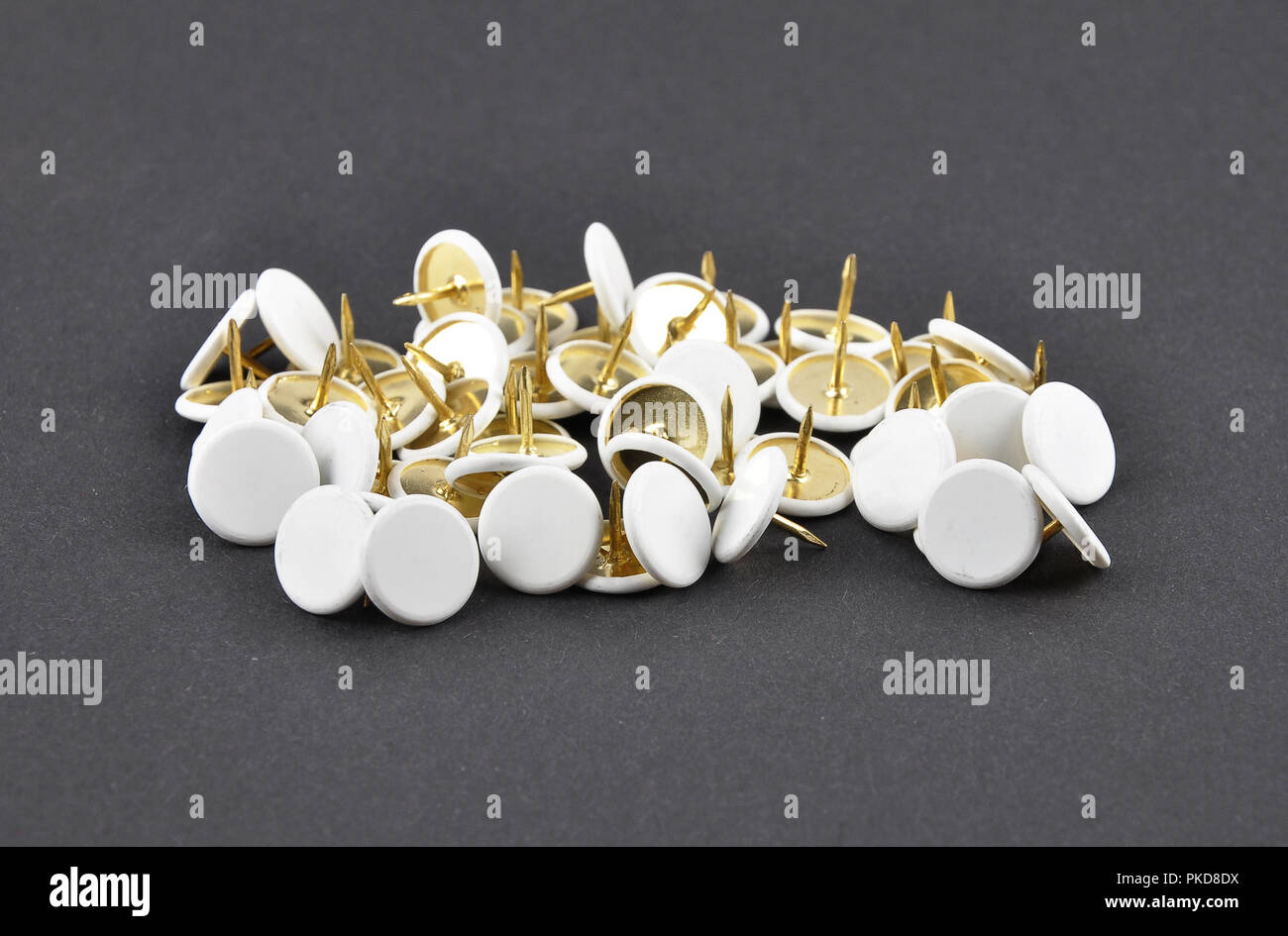 Drawing pins on black Stock Photo - Alamy