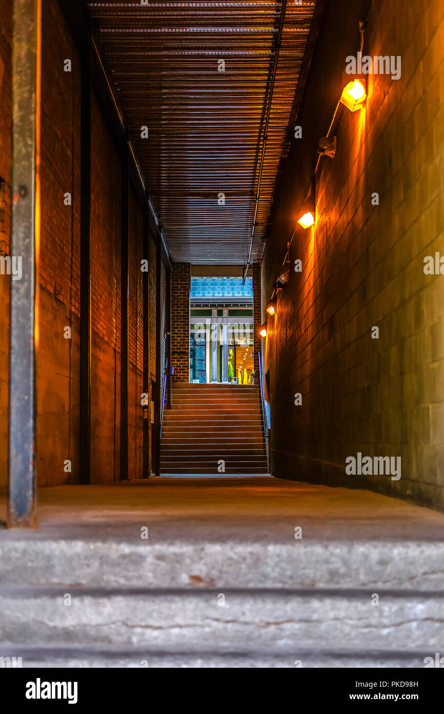 Alley way between buildings with tunnel downtown Stock Photo - Alamy