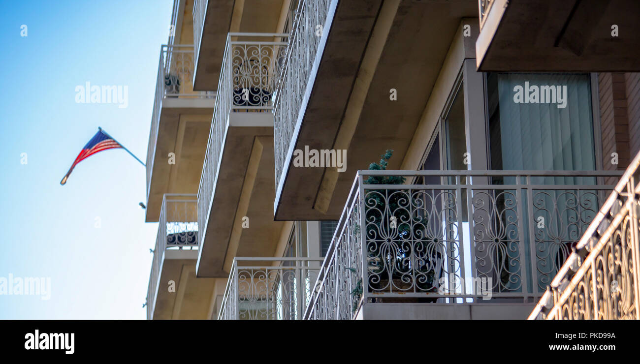 American Flag on building waving in the wind Stock Photo - Alamy