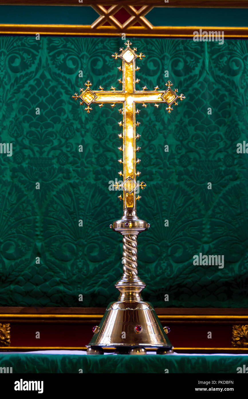 Gold cross on red background Stock Photo - Alamy