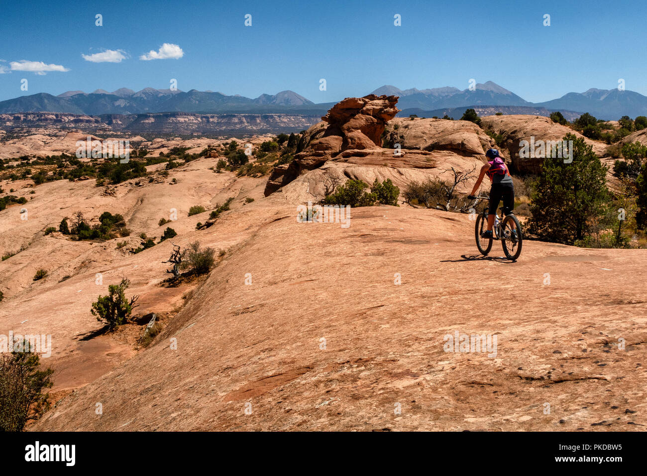 A woman rides a mountain bike on the world famous Slickrock trail in ...