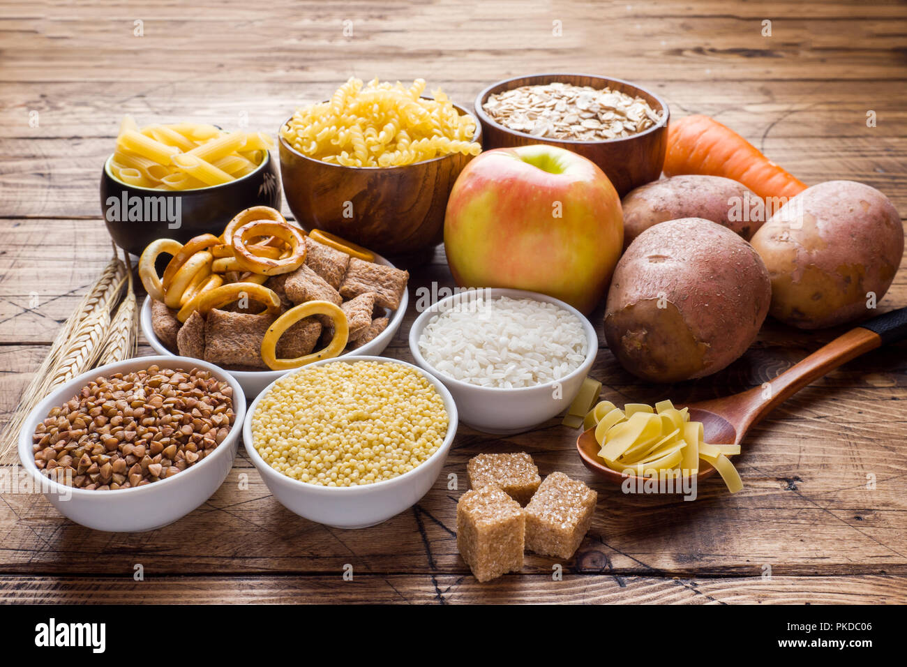 Foods high in carbohydrate on rustic wooden background Stock Photo - Alamy