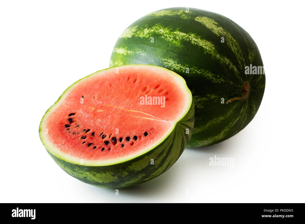 Half watermelon with seeds next to whole watermelon isolated on white ...