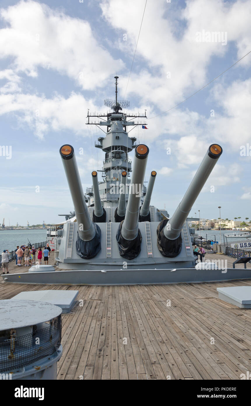 Tourists walk past gun turrets on USS Missouri (the ship on which the ...