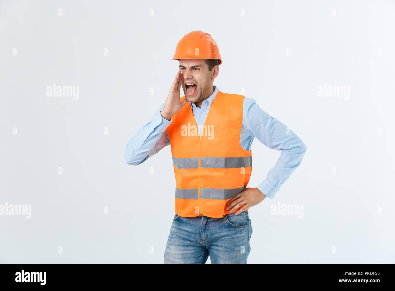 Angry engineer with angry face emotion shouting at someone raising his ...