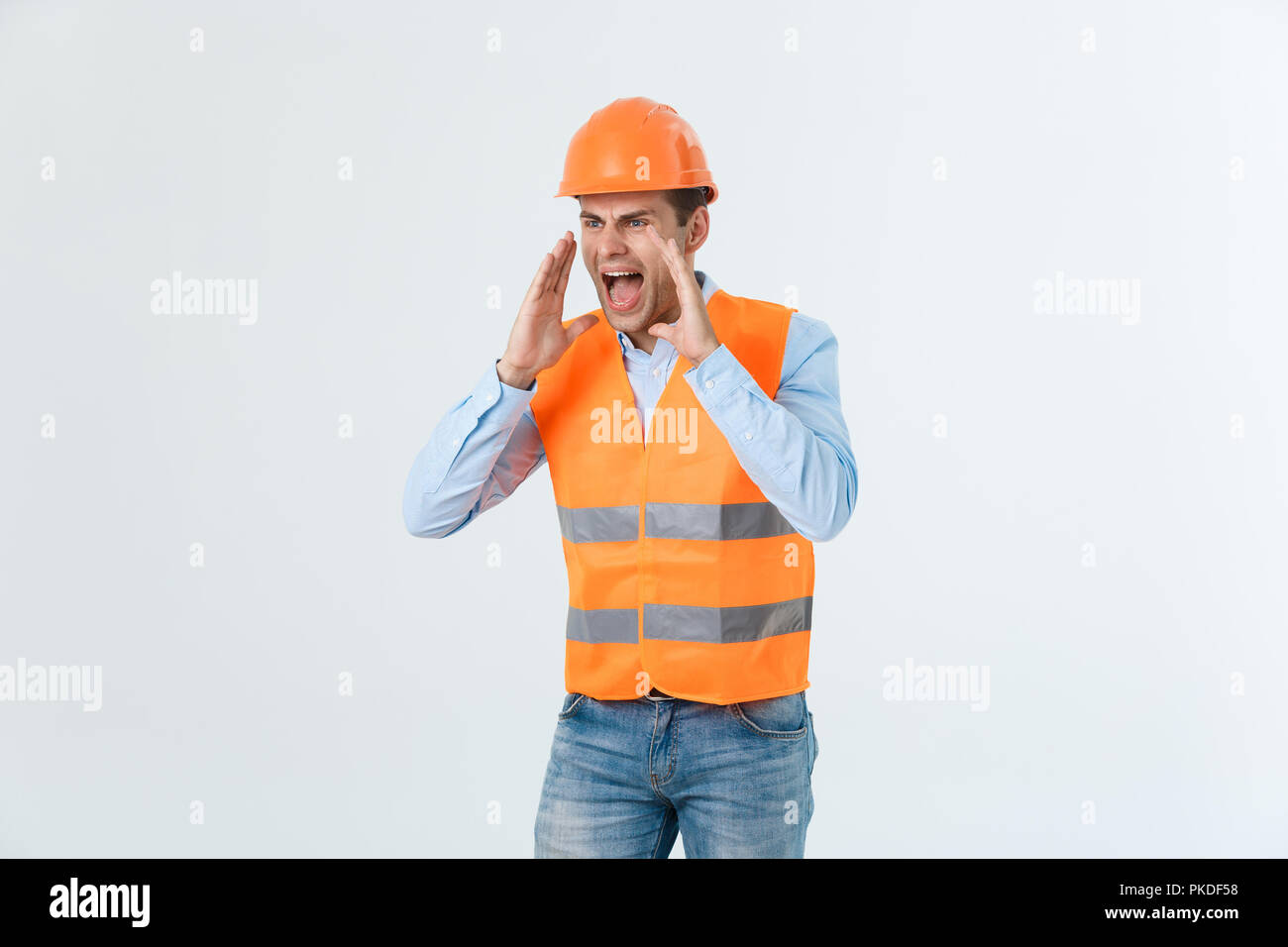 Angry engineer with angry face emotion shouting at someone raising his ...
