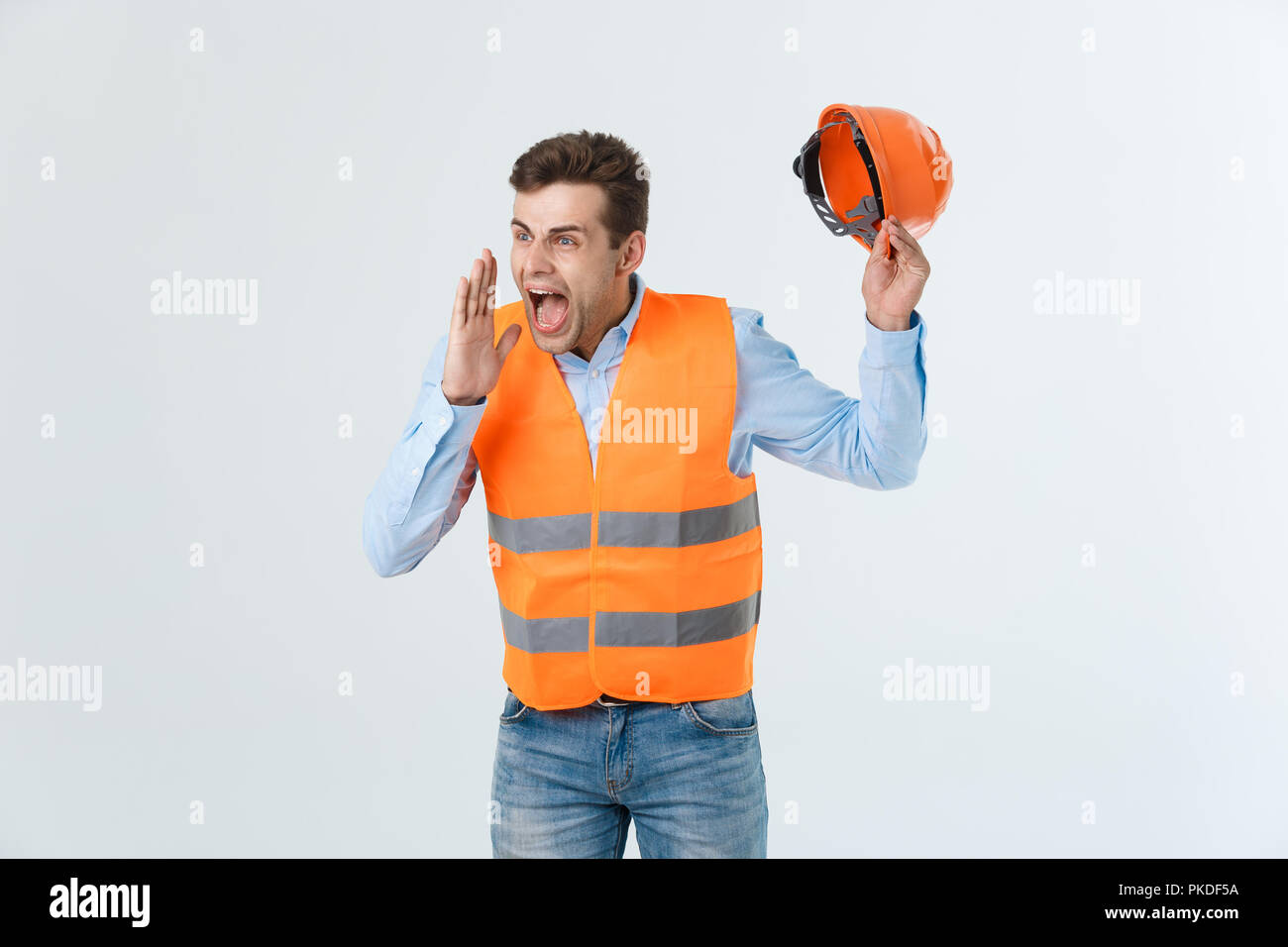 Angry engineer with angry face emotion shouting at someone raising his ...