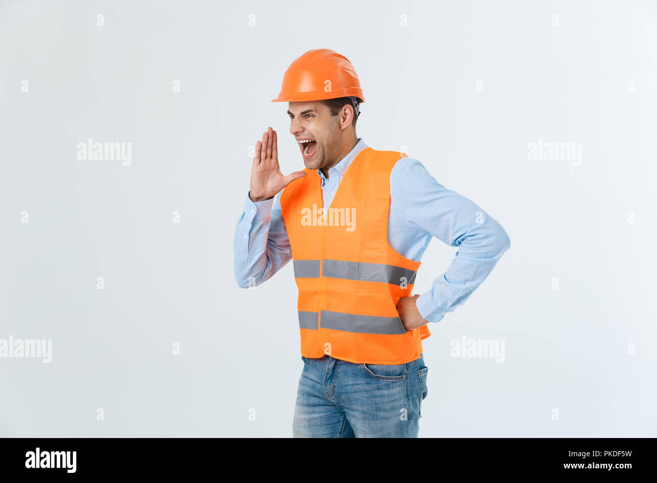 Angry engineer with angry face emotion shouting at someone raising his ...
