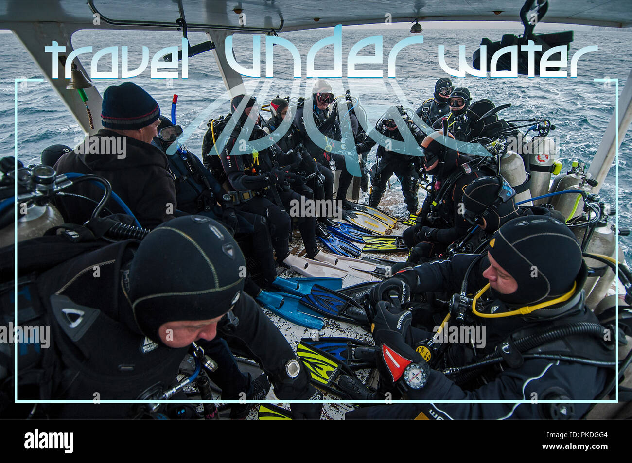 scuba divers prepare for a dive, a trip under water poster Stock Photo ...
