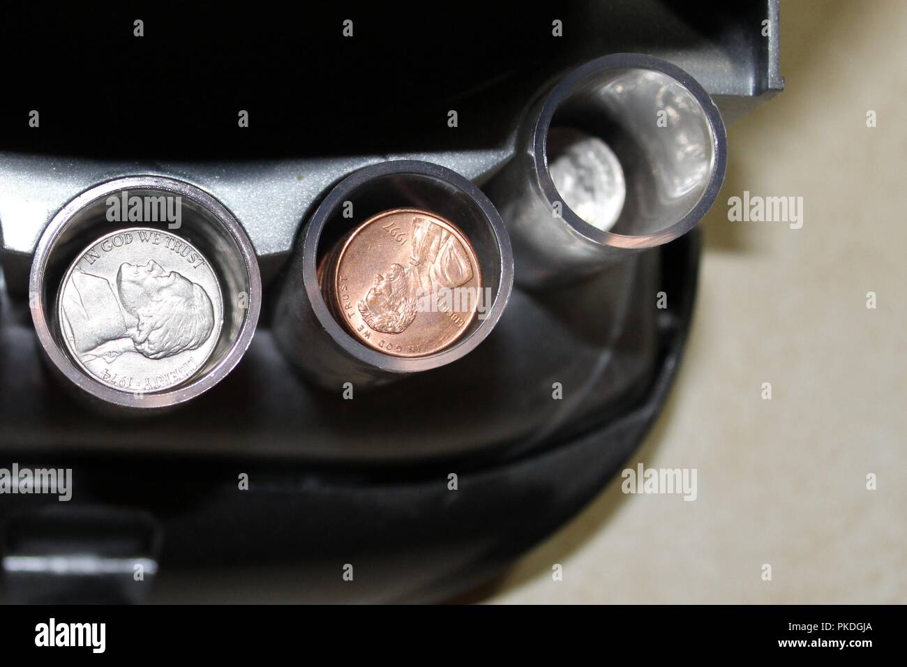 Coins in a coin sorter Stock Photo - Alamy