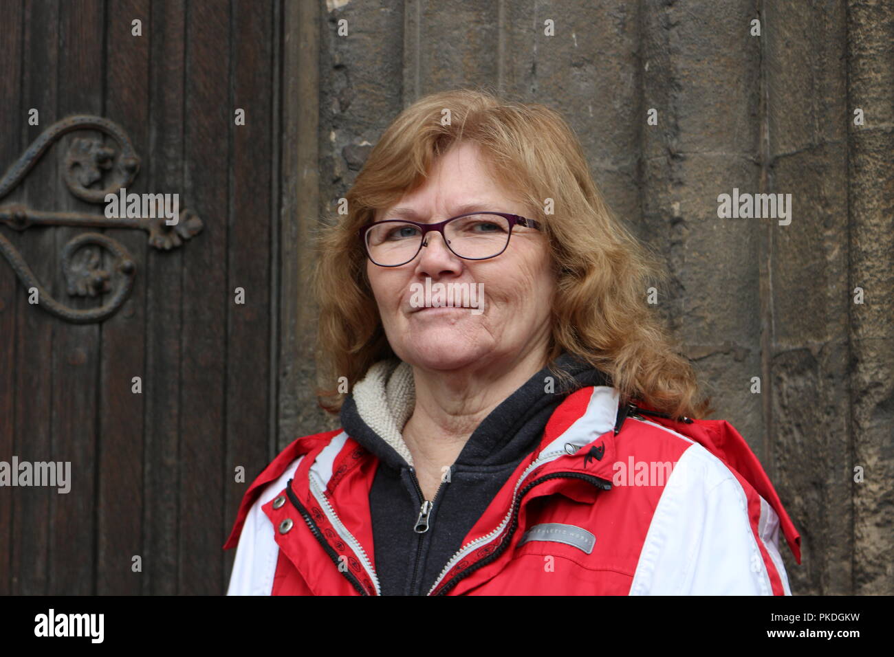 Mature irish woman expressions, portrait against an ancient building ...