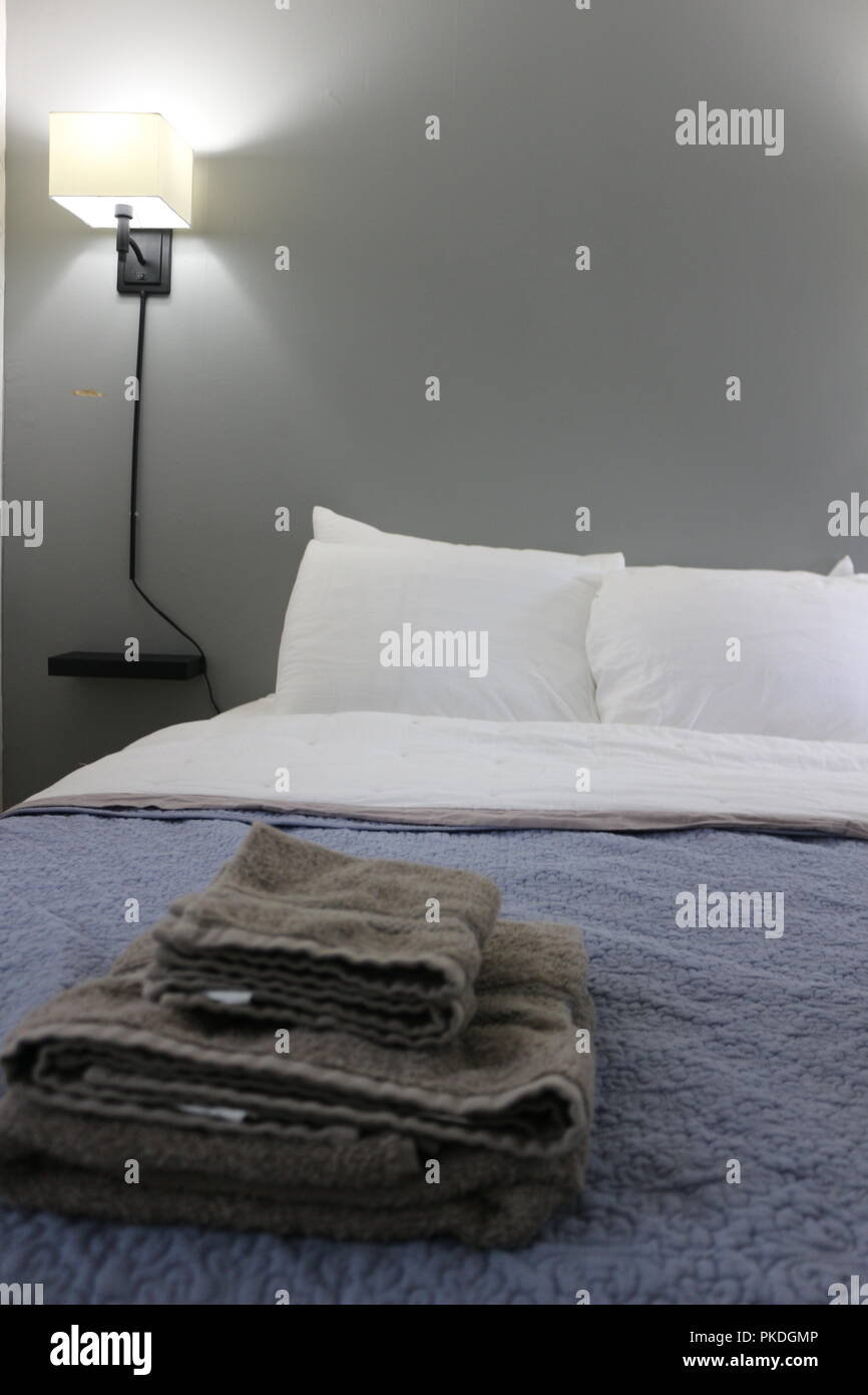 Simple student-style dorm bedroom with lots of light Stock Photo - Alamy