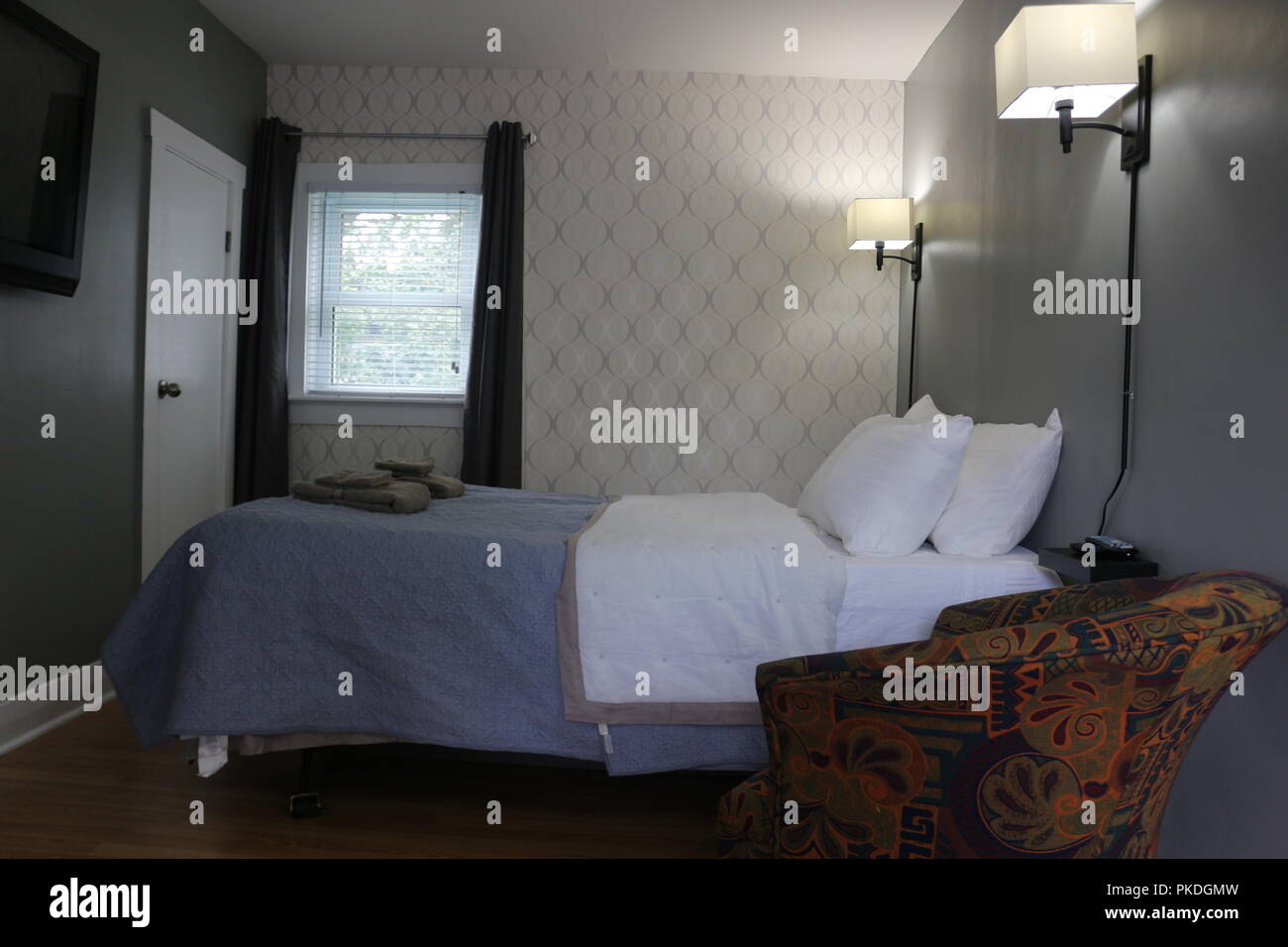 Simple student-style dorm bedroom with lots of light Stock Photo - Alamy