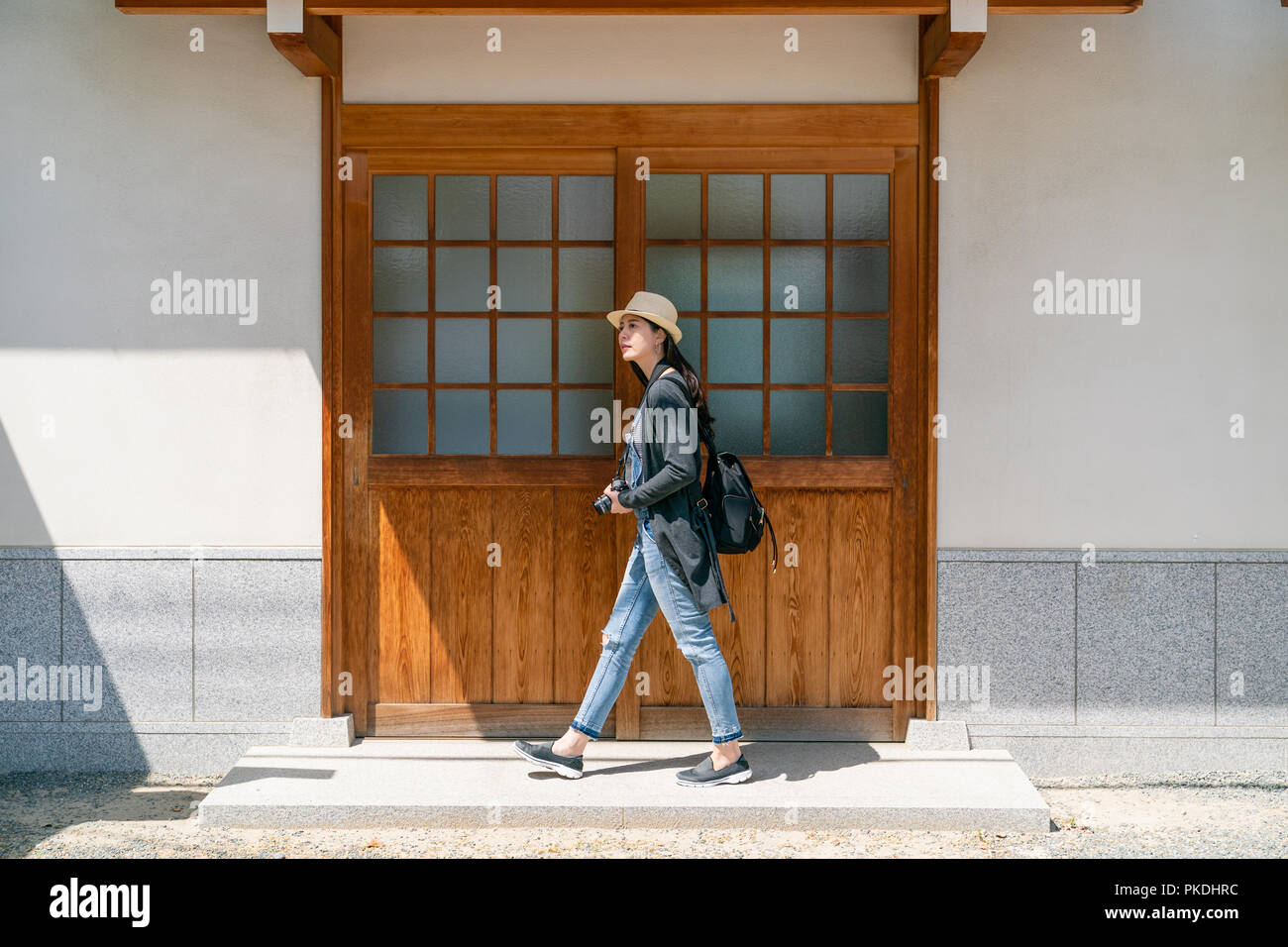 beautiful travel woman passing thru a traditional building and browsing ...