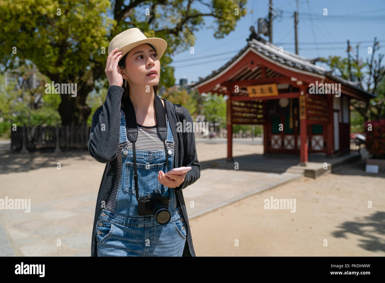 beautiful travle woman searching by phone and looking around to find ...