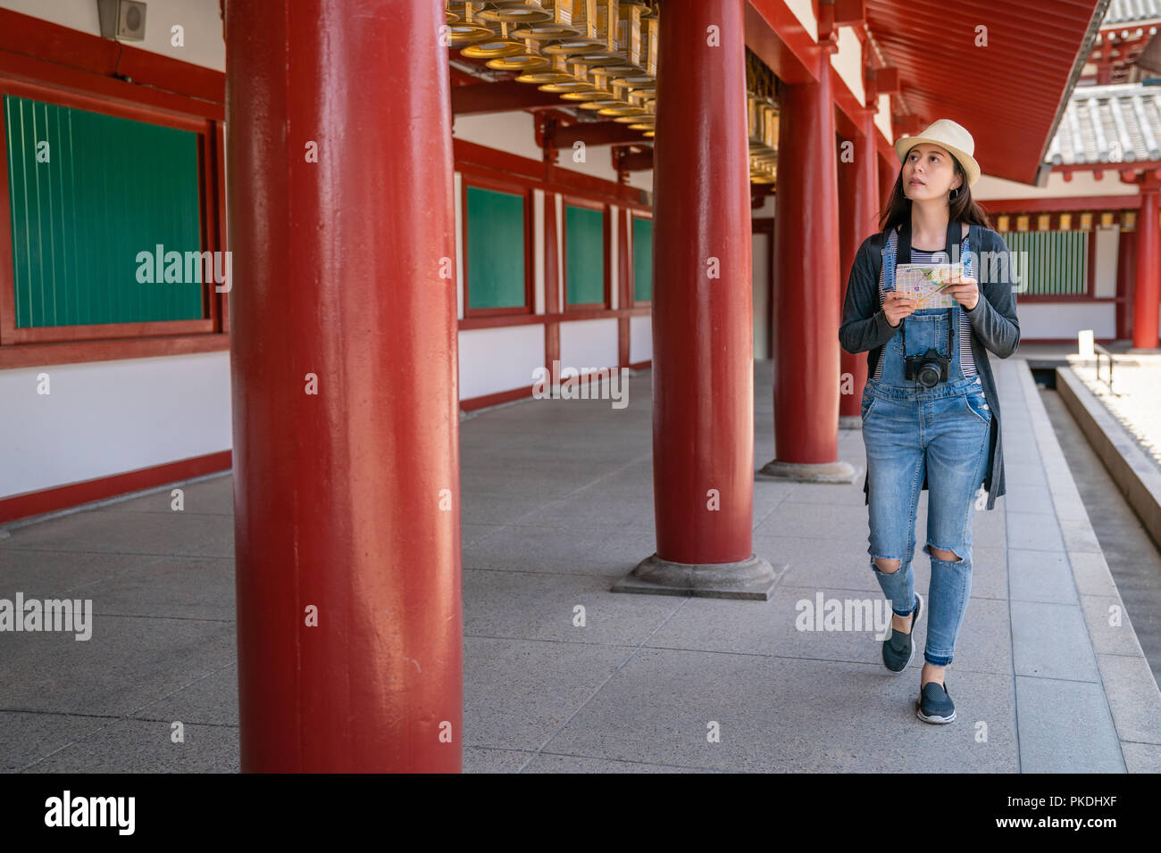 attractive woman searching for the destination by a guide map while ...