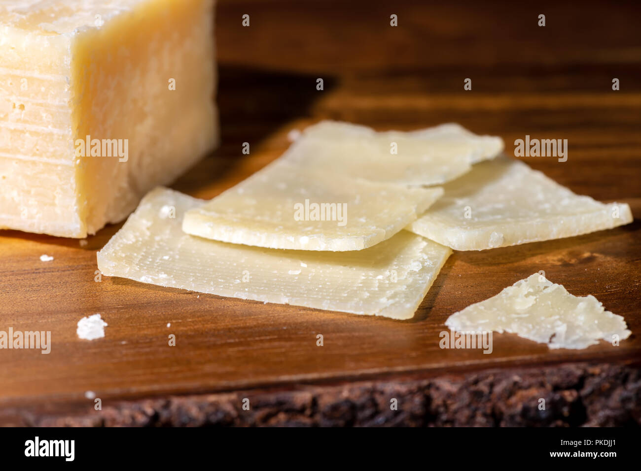 close up portion and slaced of fresh parmesan cheese on wooden ...