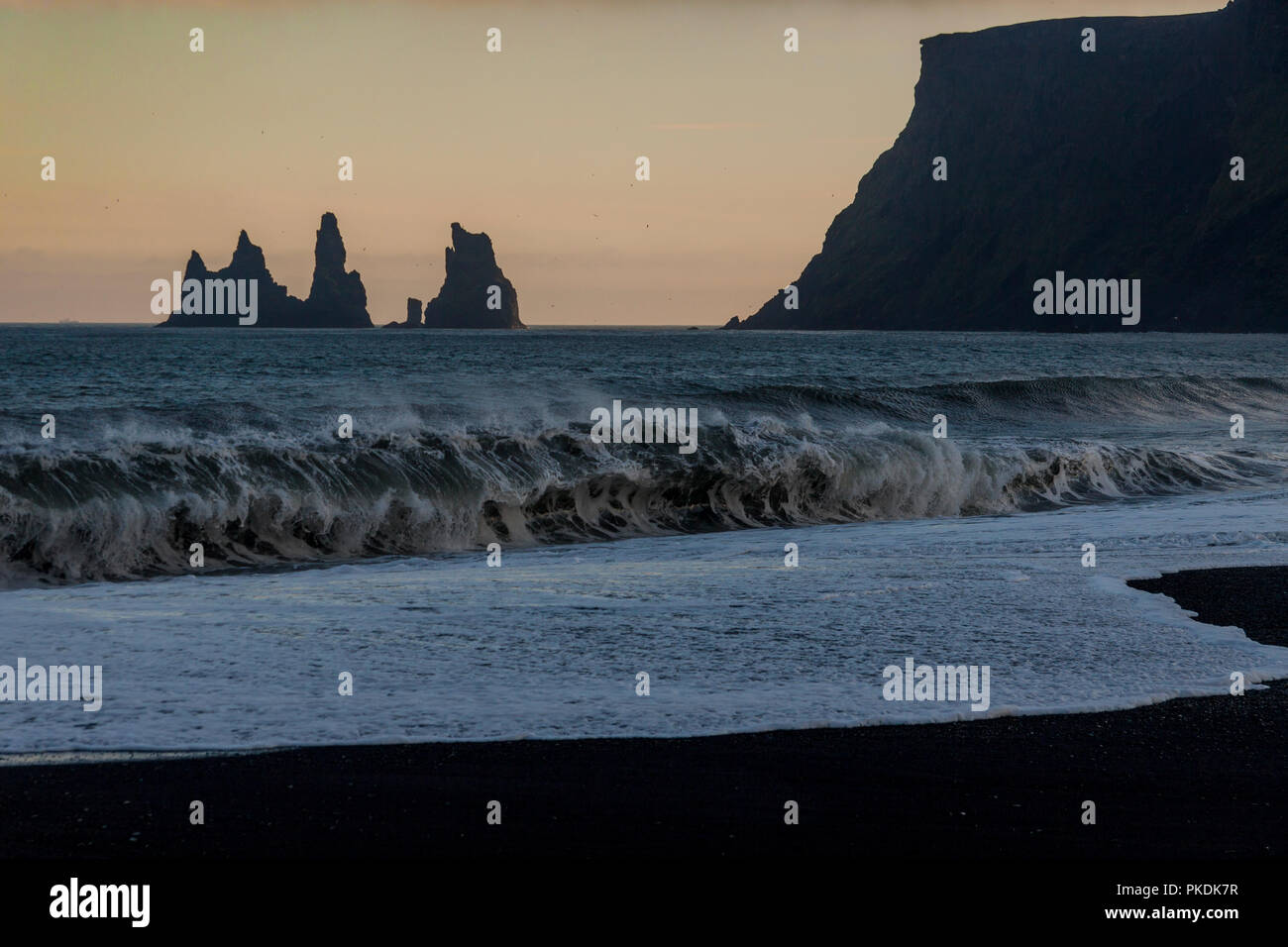 Reynisdrangar rock formations and the mount Reynisfjall. Black beach in ...